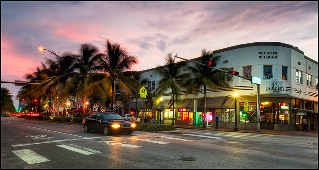 South Beach at Dusk: Washington Ave & 15th Street, palm silhouettes and neon storefronts beside the Chandler Building