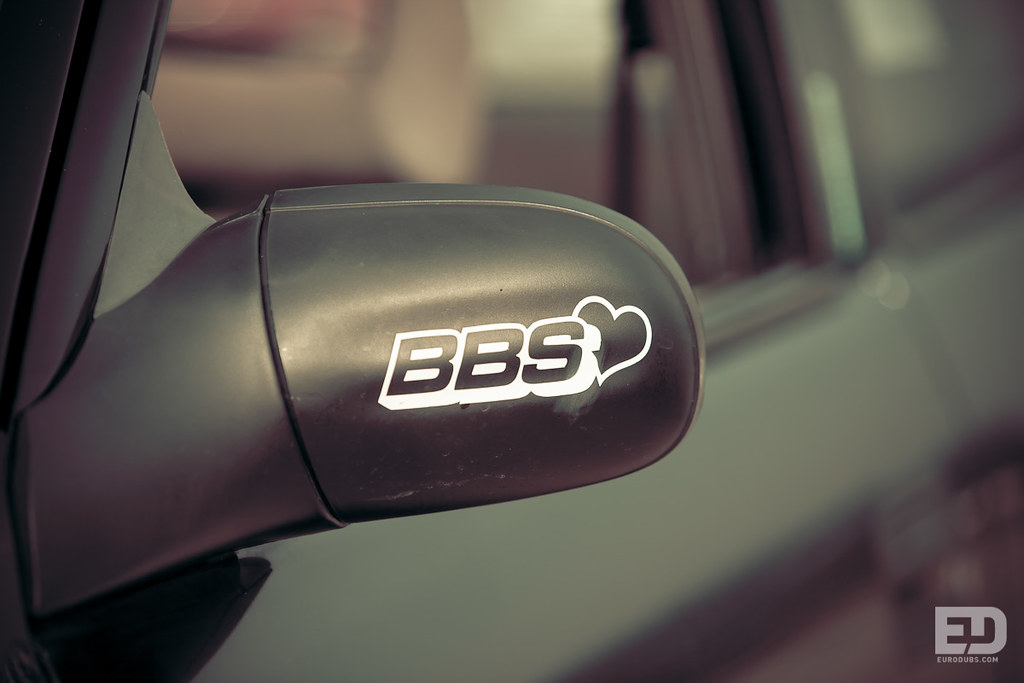 Close-up of BBS emblem on a car side-mirror housing, shallow depth of field