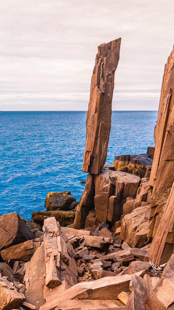 Balanced Rock Spire Along a Rugged Coastal Shore