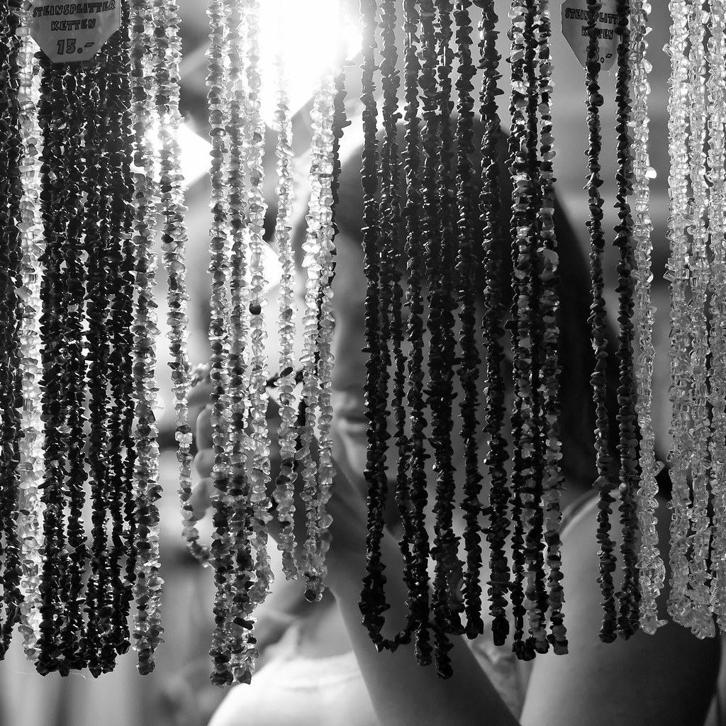 Backlit crystal bead strands at a market stall, price tag 15,- (Steinsplitter Ketten)