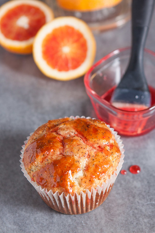 Orange-Glazed Poppy Seed Muffin with Citrus Syrup on a Gray Kitchen Counter — Close-Up