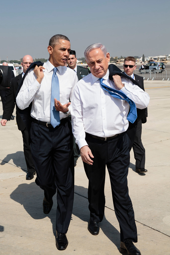 Ben Gurion Airport Arrival, March 20, 2013: two senior officials walk the tarmac in daylight.