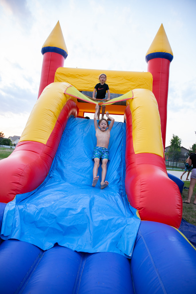 Children on a Colorful Inflatable Slide at Fort Collins Neighborhood Night Out