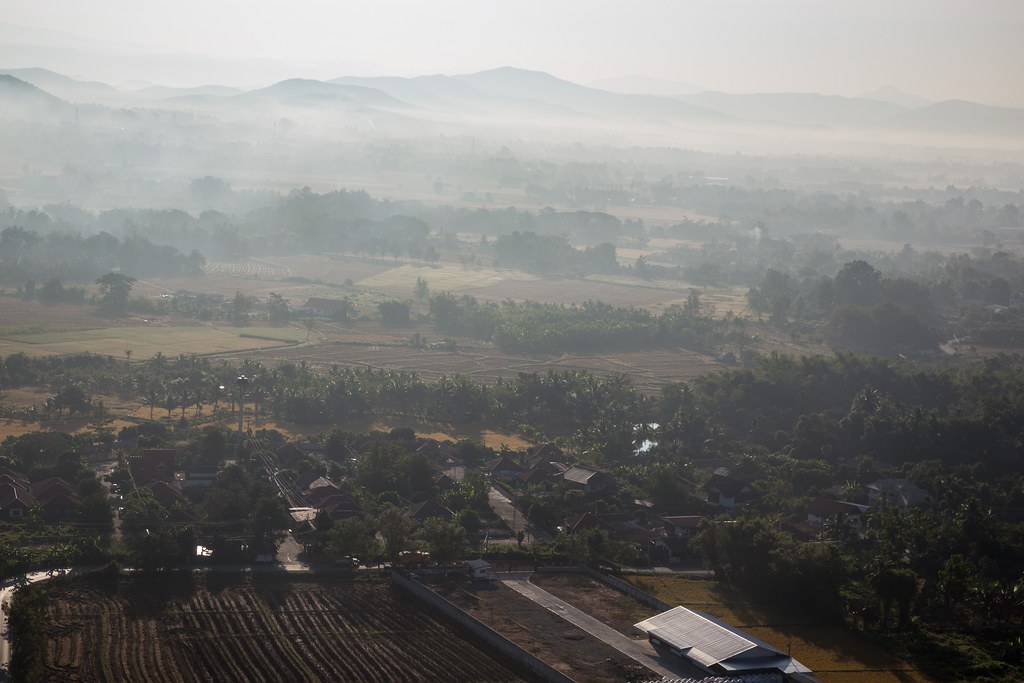 Dawn Mist Over a Thai Countryside: Rice Fields, Villages, and Distant Hills