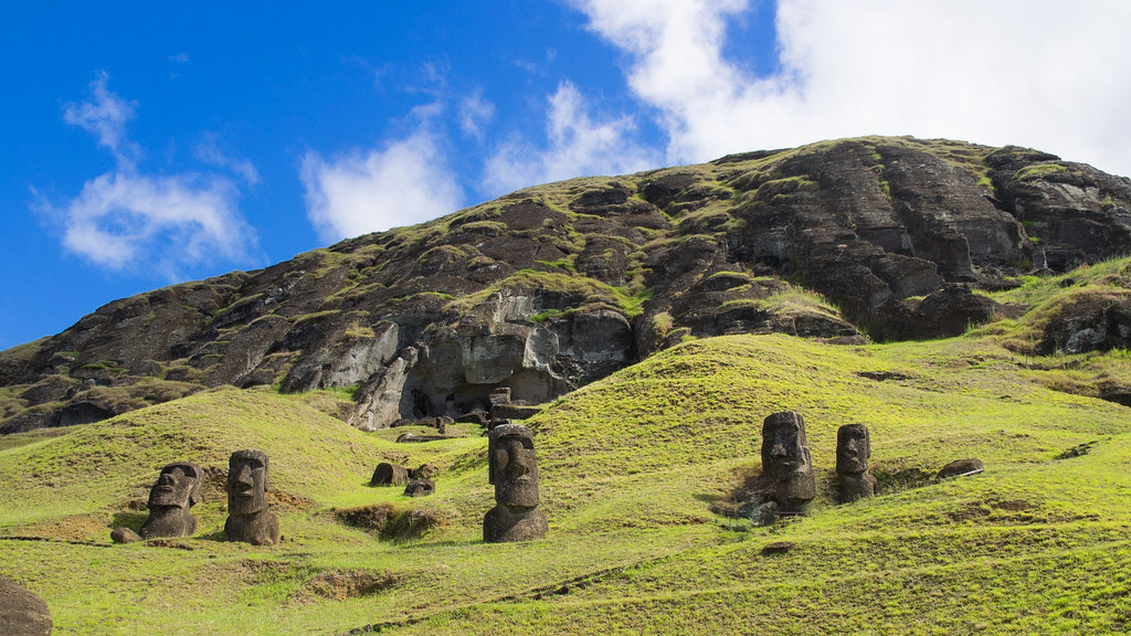 Rano Raraku Quarry on Easter Island: Moai Standing Among Green Slopes Beneath a Rugged Ridge