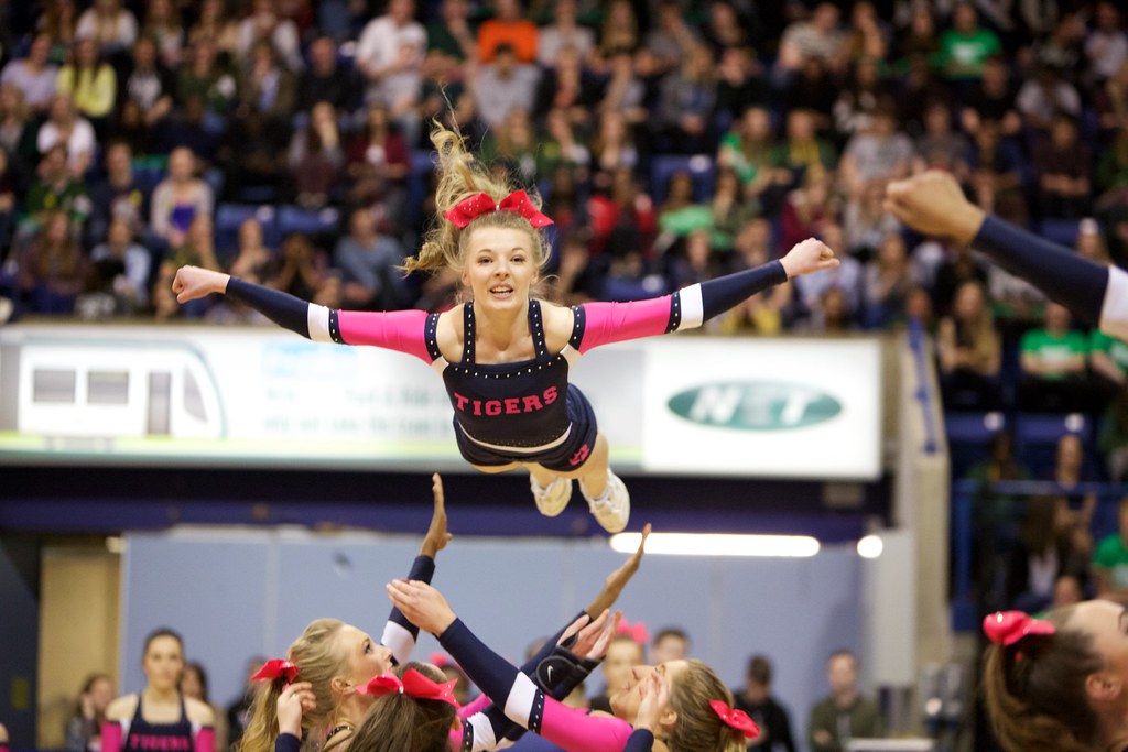 Tigers Varsity Cheer Team Executes a High-Flying Stunt During a 2015 Basketball Game